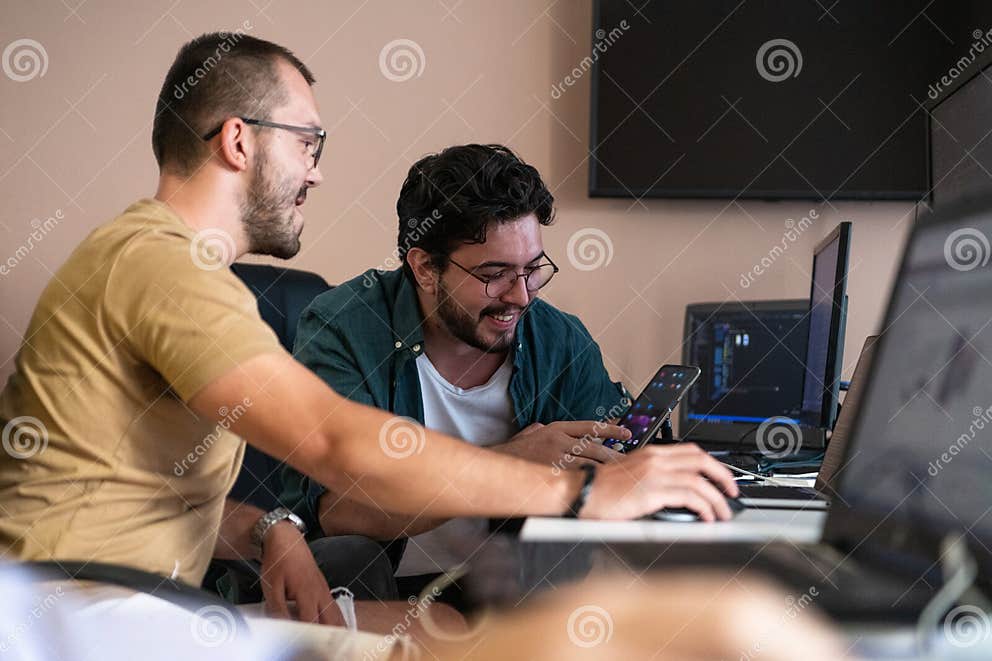 Collaborative Minds: a Team of Programmers Tackling Challenges Together in the Office. Stock ...