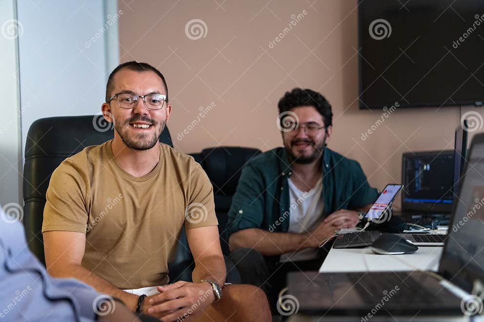 Collaborative Minds: a Team of Programmers Tackling Challenges Together in the Office. Stock ...