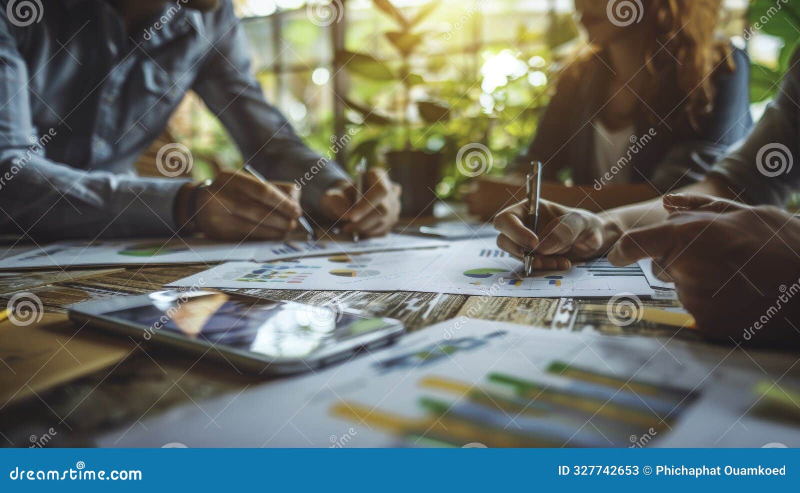 Collaborative Team Meeting with Charts and Graphs Discussing Strategy ...