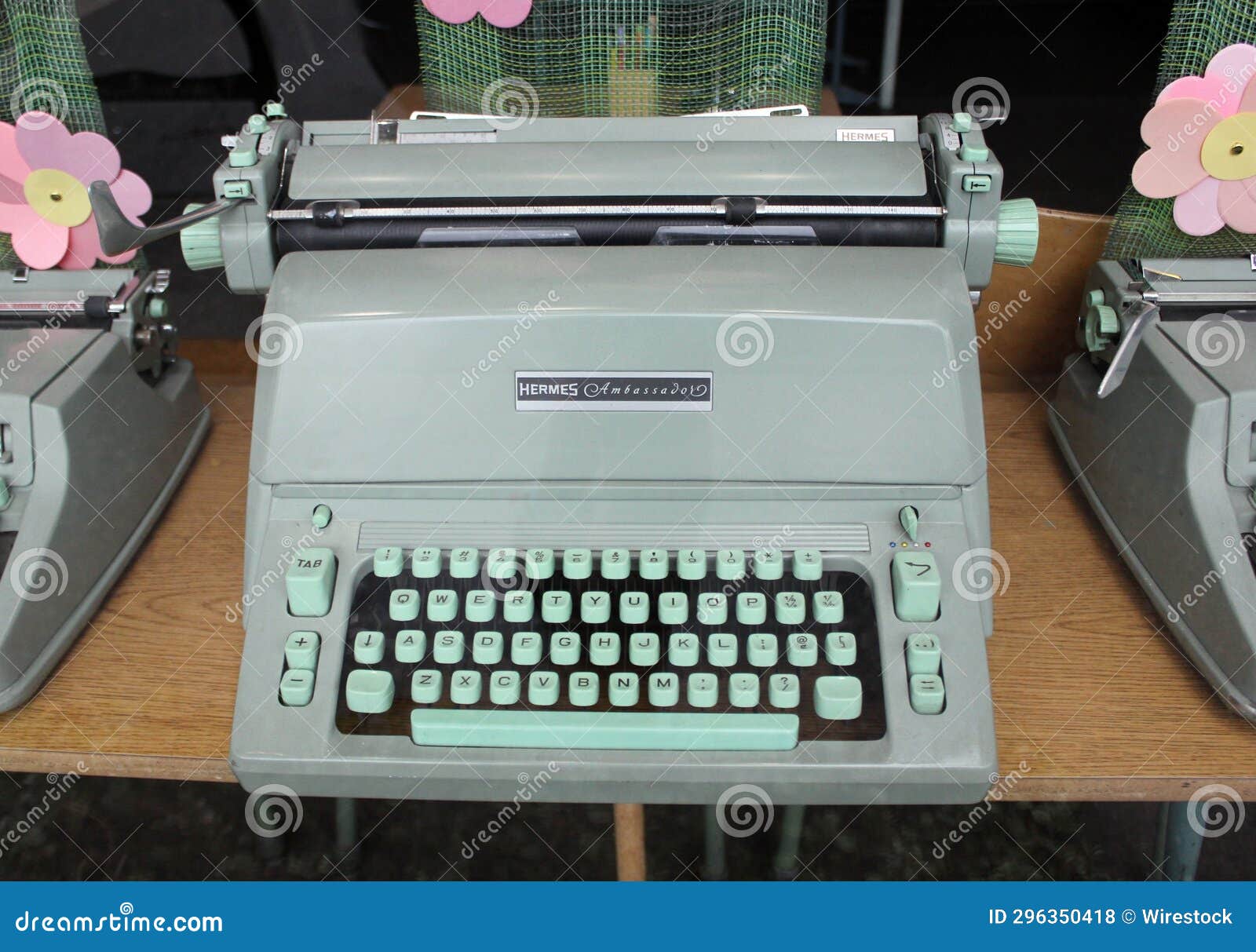 Three Antique Typewriters Are Set On A Table With Flowers Editorial