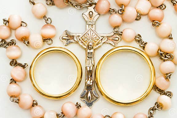 Crucifix and wedding rings stock photo. Image of church - 112332060