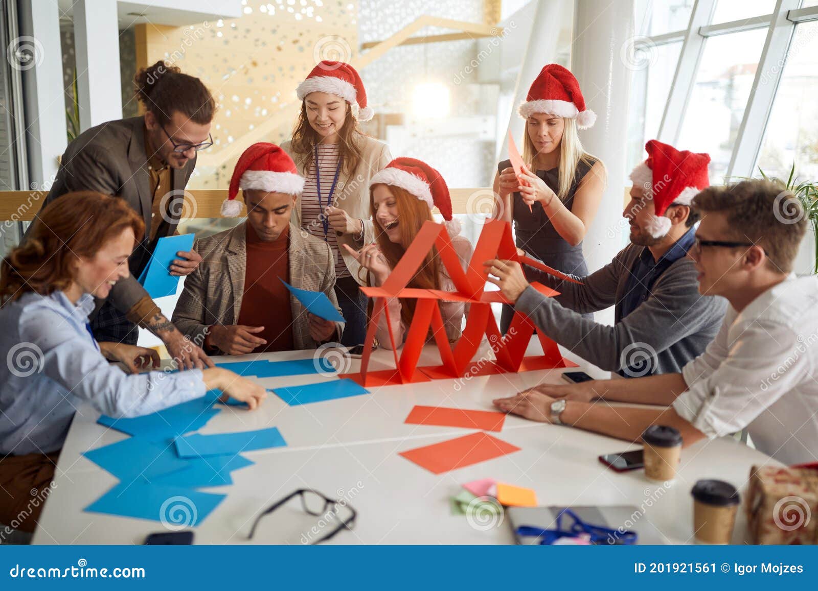 Colleagues Building Paper Towers at Work in the Office for Christmas ...