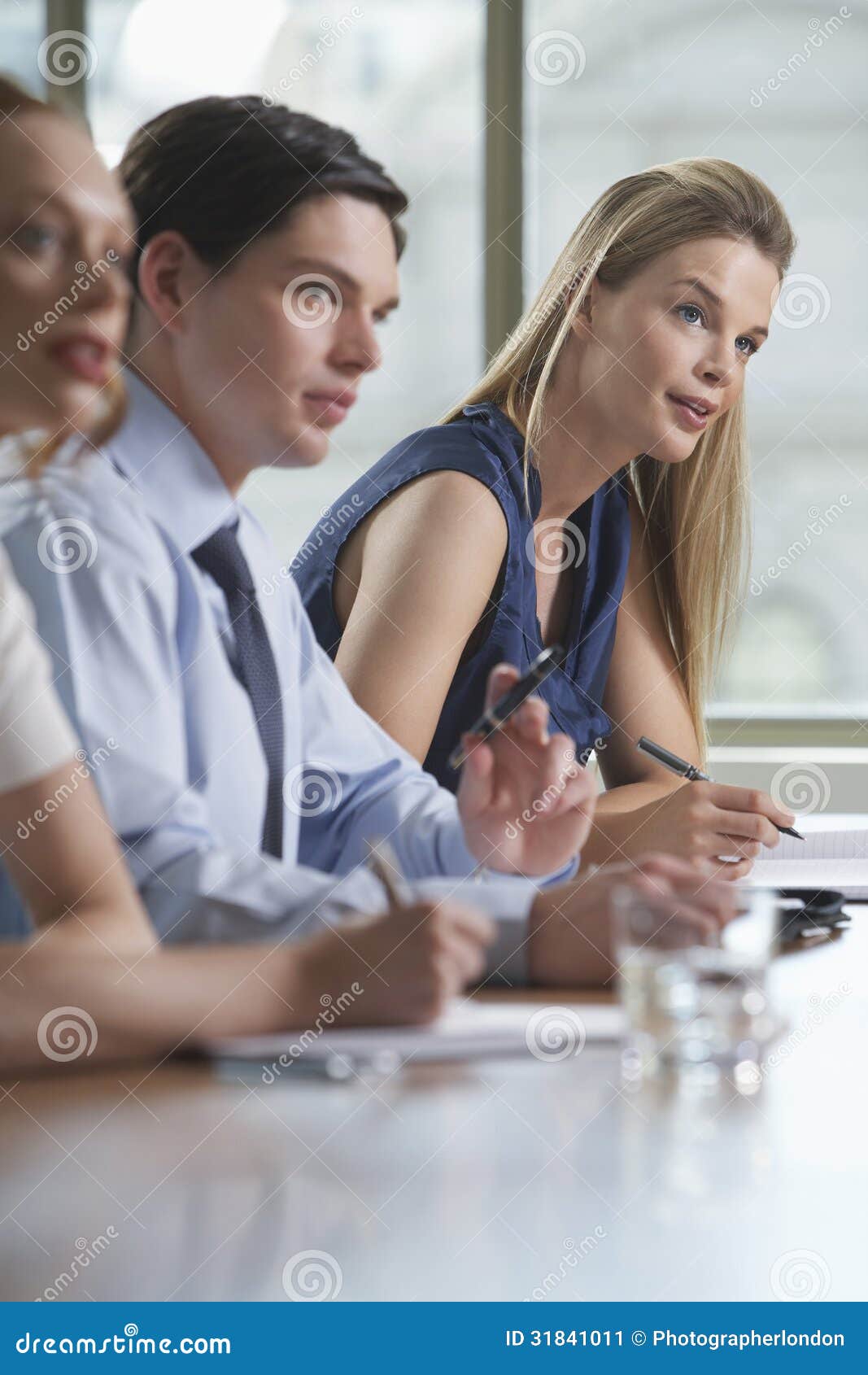 Colleagues at Business Meeting Stock Image - Image of document, looking ...