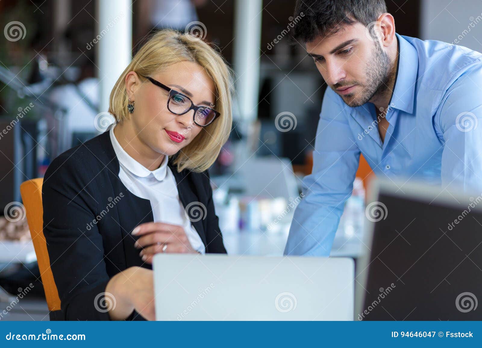 Colleagues Chatting, Sitting Together at Office Table, Smiling Stock ...