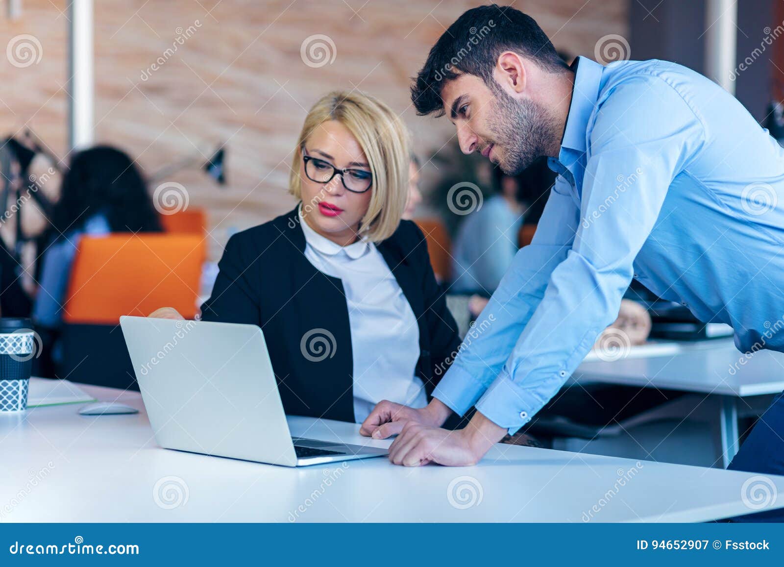 Colleagues Chatting, Sitting Together at Office Table, Smiling Stock ...