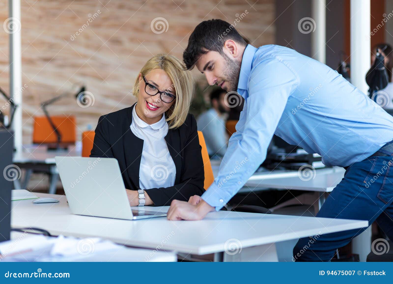 Colleagues Chatting, Sitting Together at Office Table, Smiling Stock ...