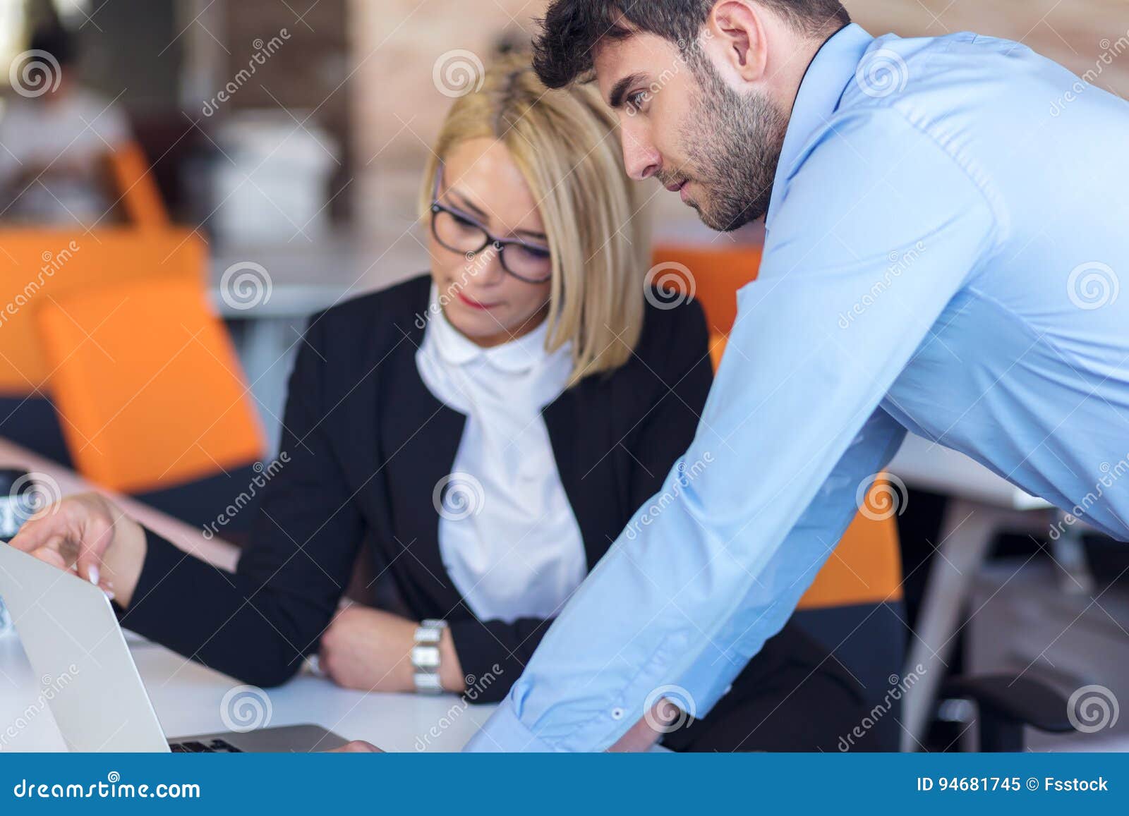 Colleagues Chatting, Sitting Together at Office Table, Smiling Stock ...