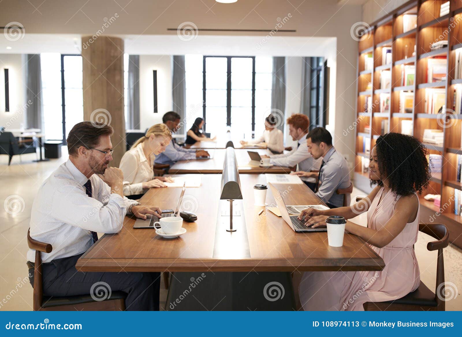Colleagues at Desks in a Busy Open Plan Office, Close Up Stock Image ...