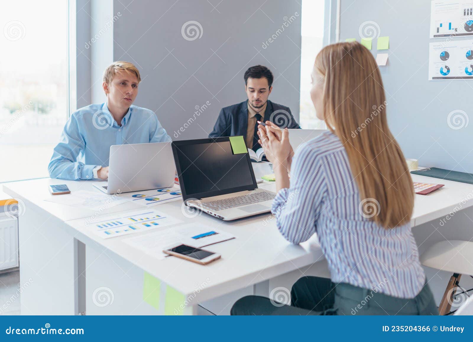 Colleagues Discussing Business Ideas while Gathering at Table in Office ...