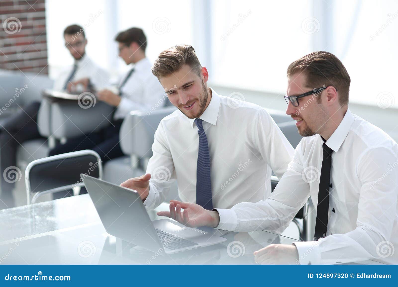 Colleagues Discussing Current Information at the Desktop Stock Photo ...