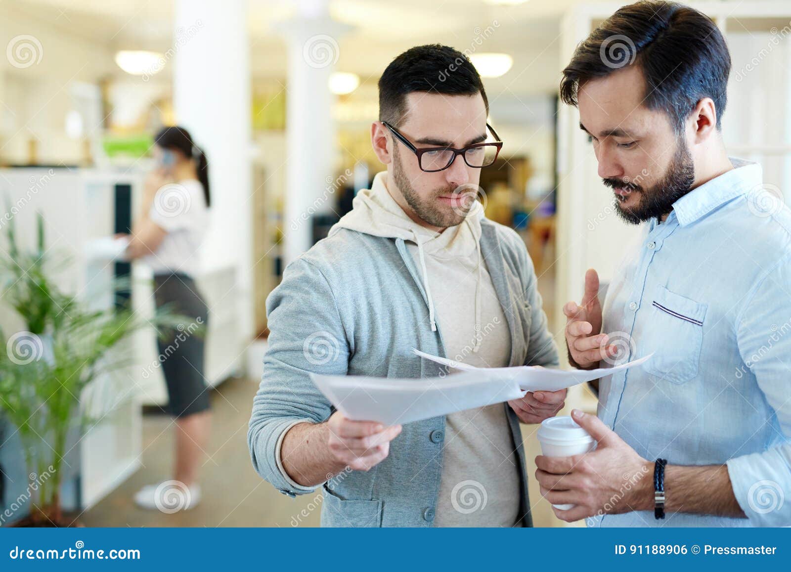 Colleagues Discussing Documents in Modern Office Stock Photo - Image of ...