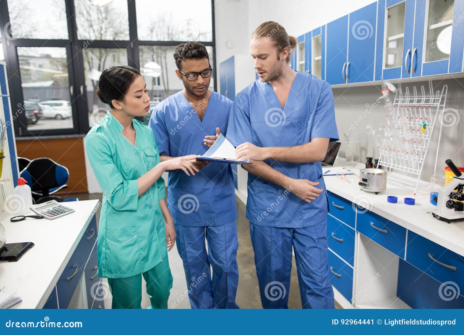 Colleagues Discussing Work in Laboratory Stock Image - Image of notepad ...
