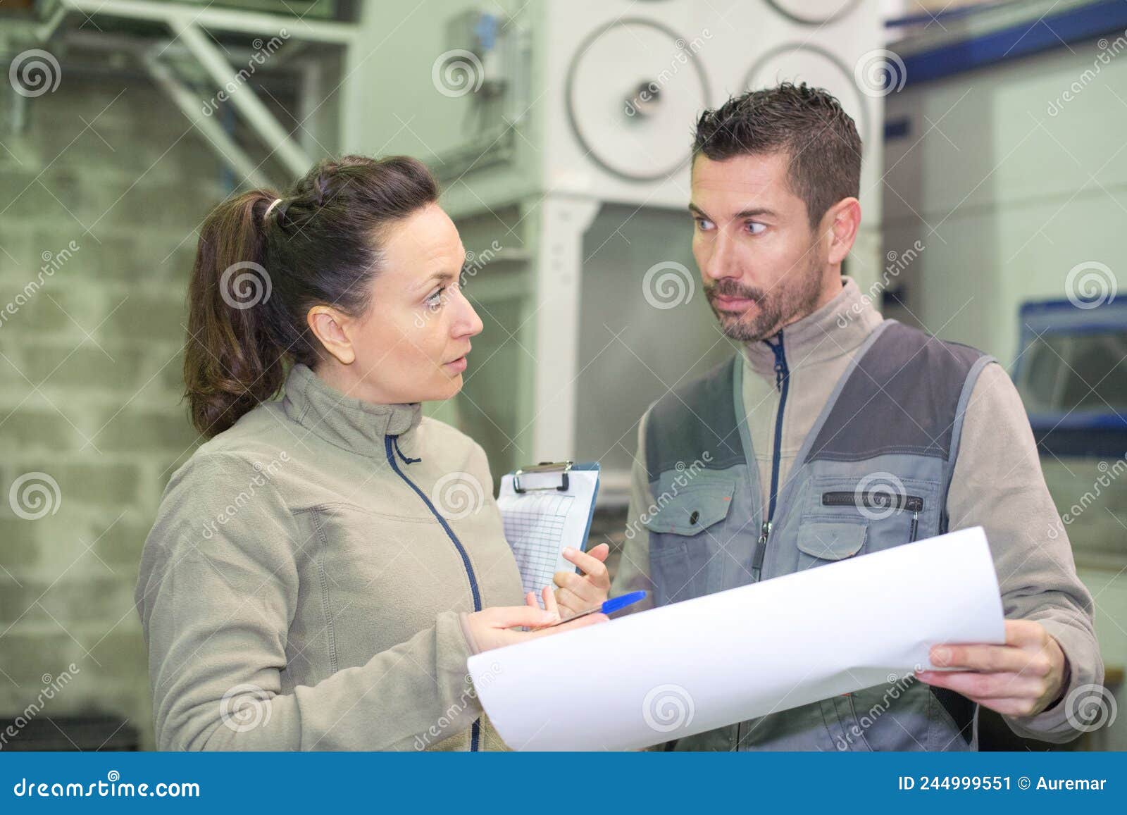 Colleagues in Discussion in Factory Looking at Paperwork Stock Image ...