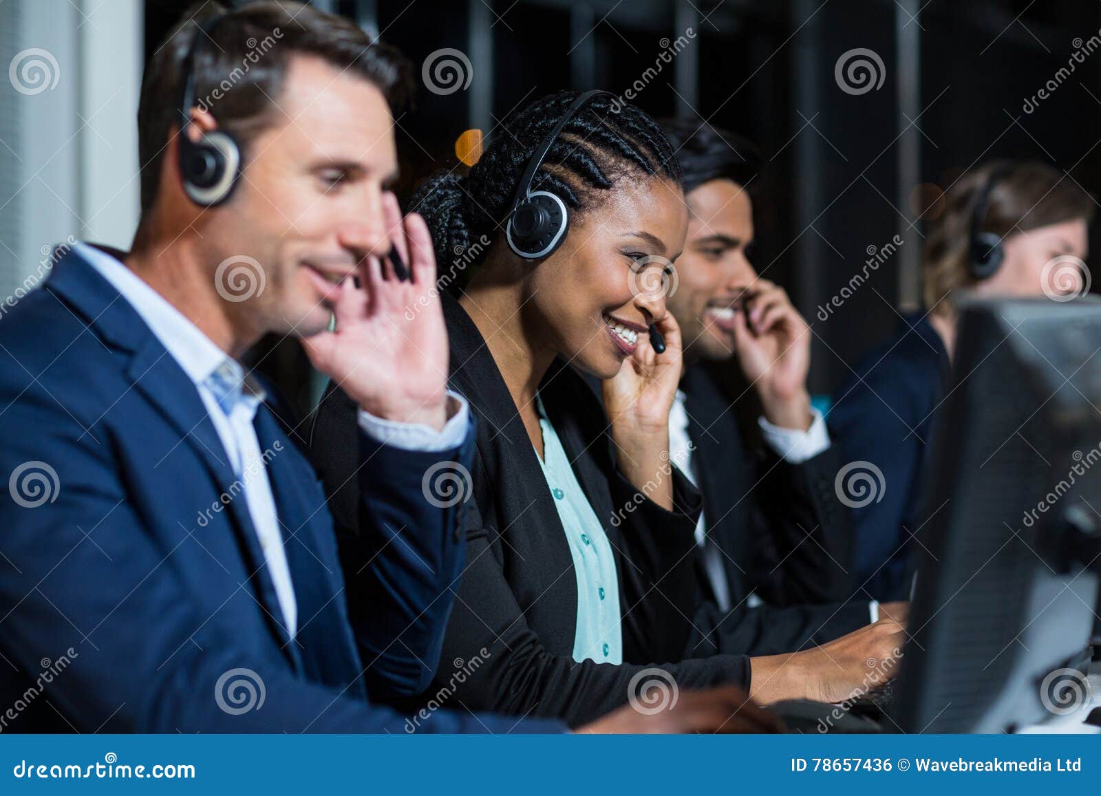Colleagues with Headsets Using Computer at Office Stock Photo - Image ...