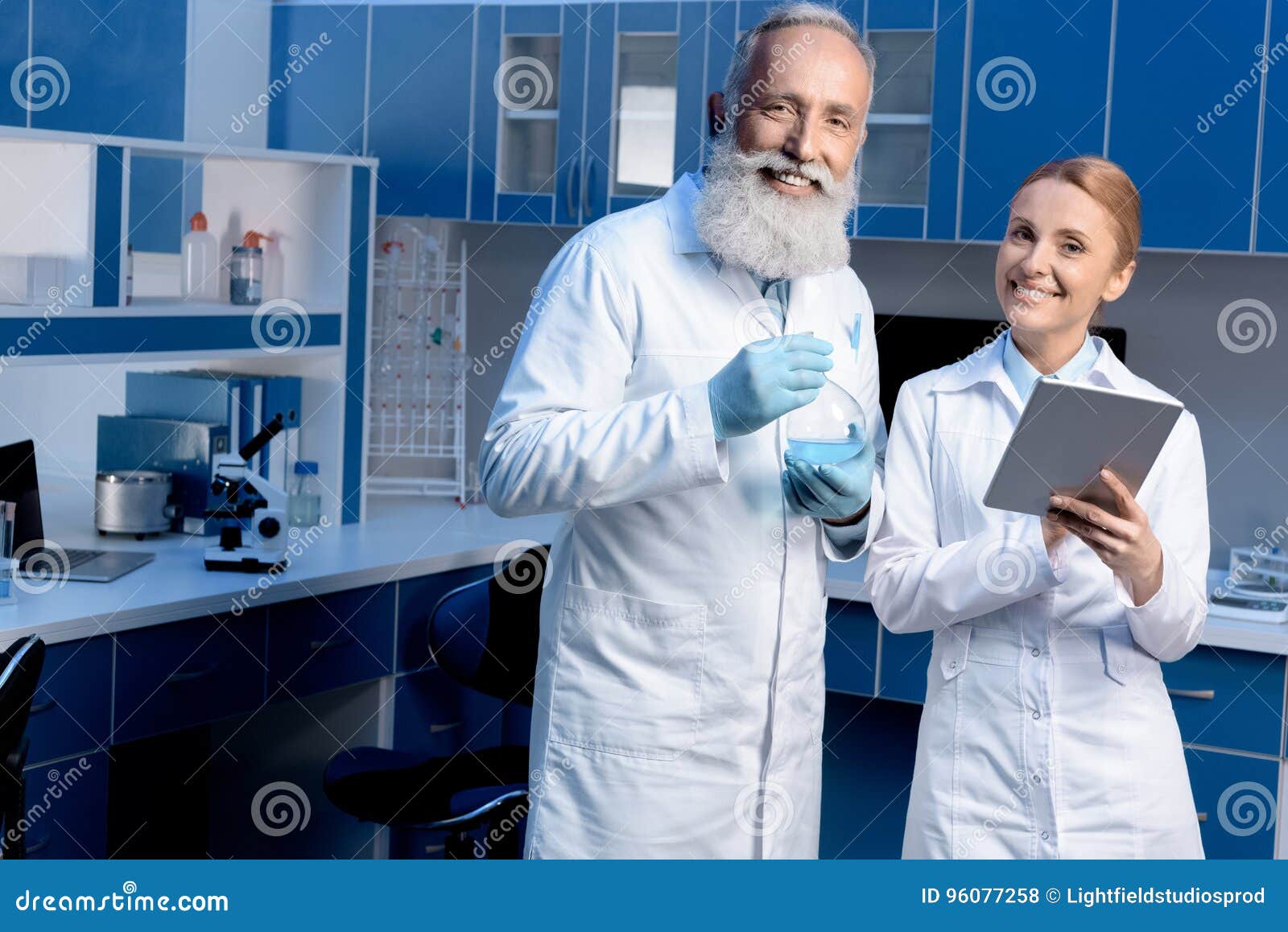 Colleagues in Lab Coats Using Digital Tablet during Work Stock Photo ...