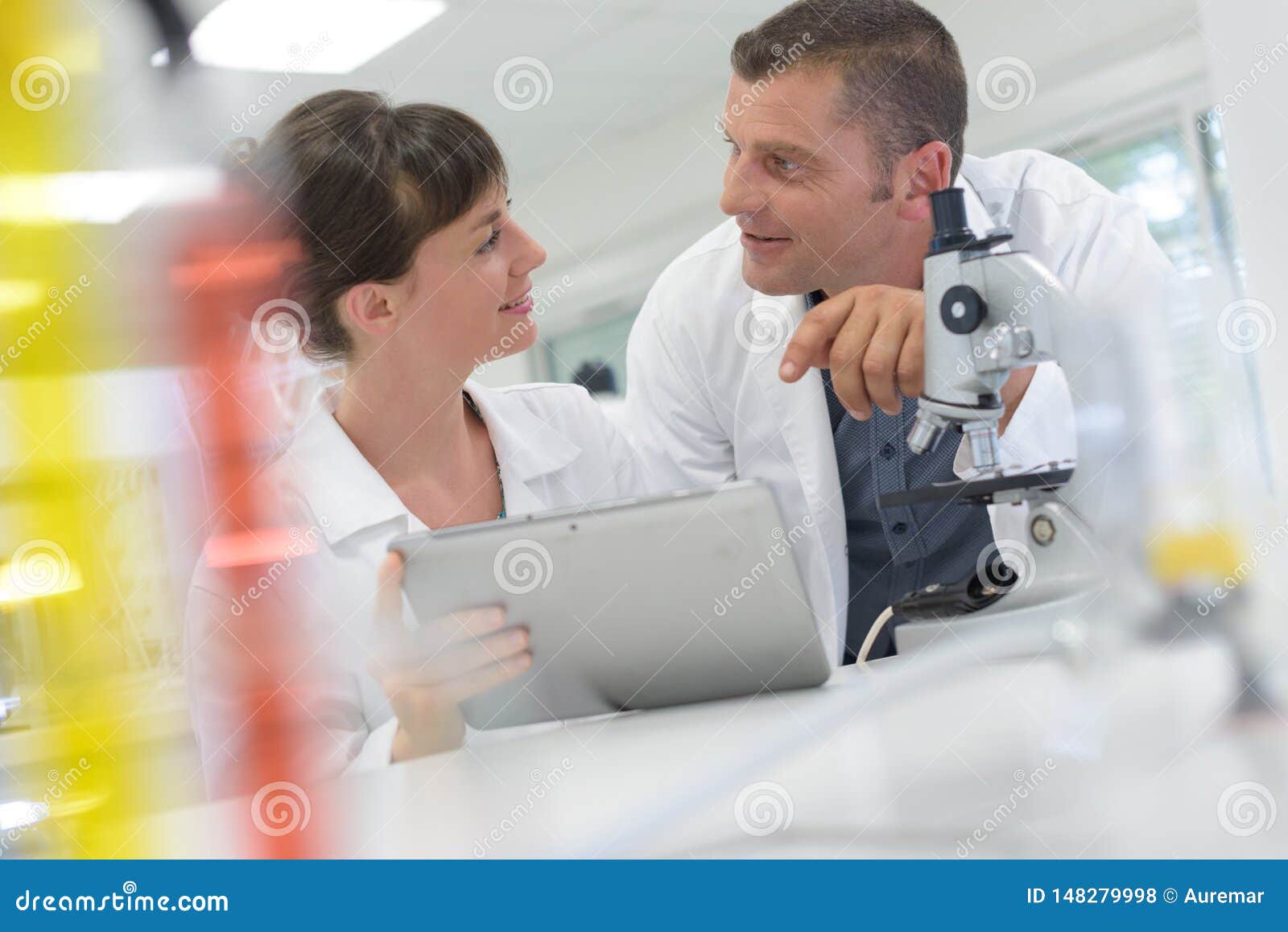 Colleagues Looking at Digital Tablet in Science Laboratory Stock Photo ...