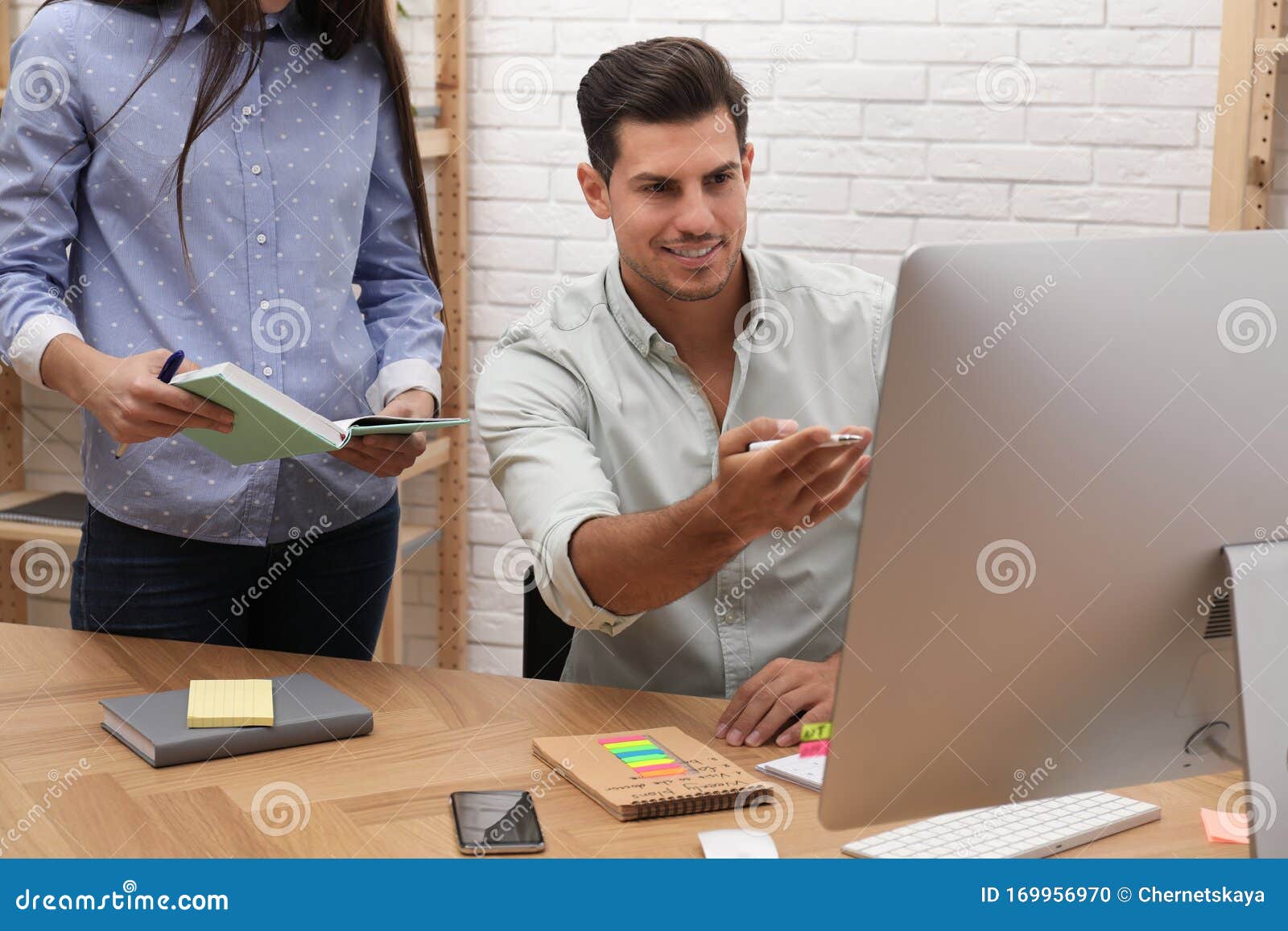 Colleagues Making Schedule Using Calendar in Office Stock Photo - Image ...