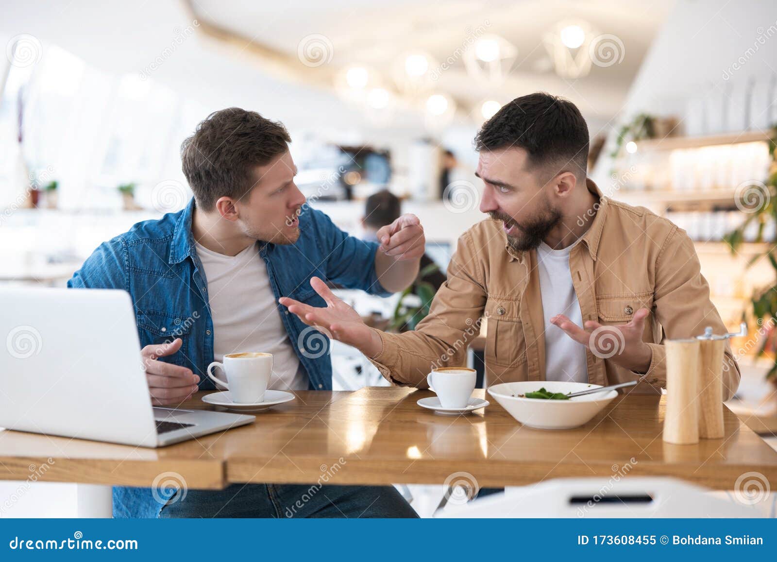 Colleagues Men Arguing about Work Issues during Lunch Break at Cafe ...