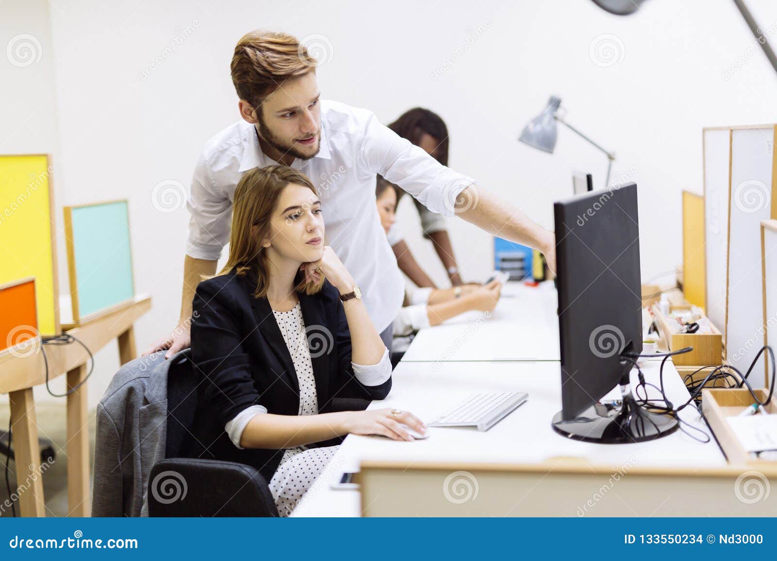 Colleagues in Office Working on a Computer Stock Photo - Image of women ...