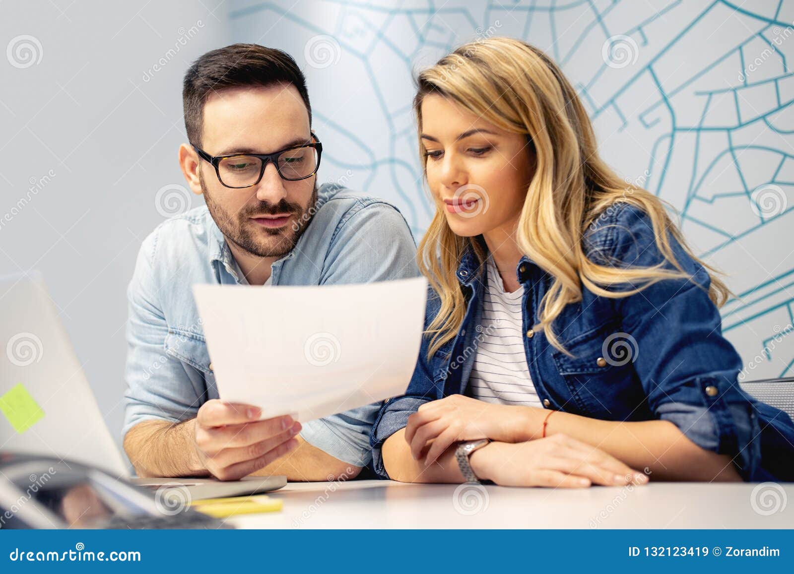Colleagues Reading Important Document Together Stock Image - Image of ...