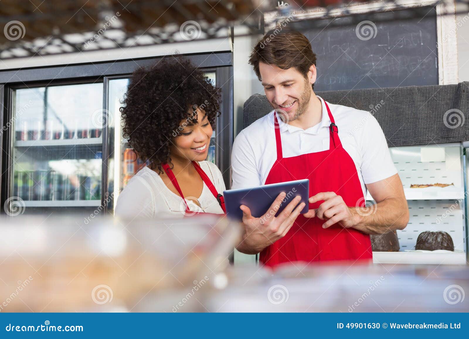 Colleagues in Red Apron Using Tablet Stock Photo - Image of coffee ...