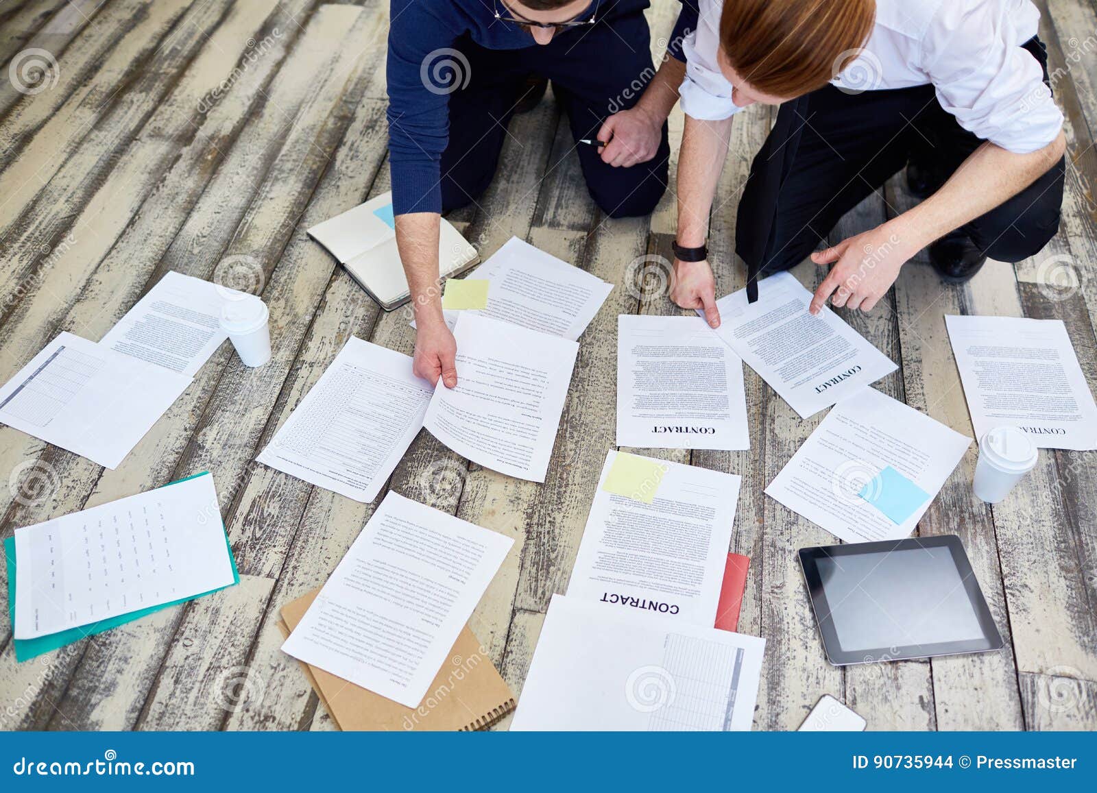 Colleagues Sorting Contract Documentation on Floor in Office Stock ...