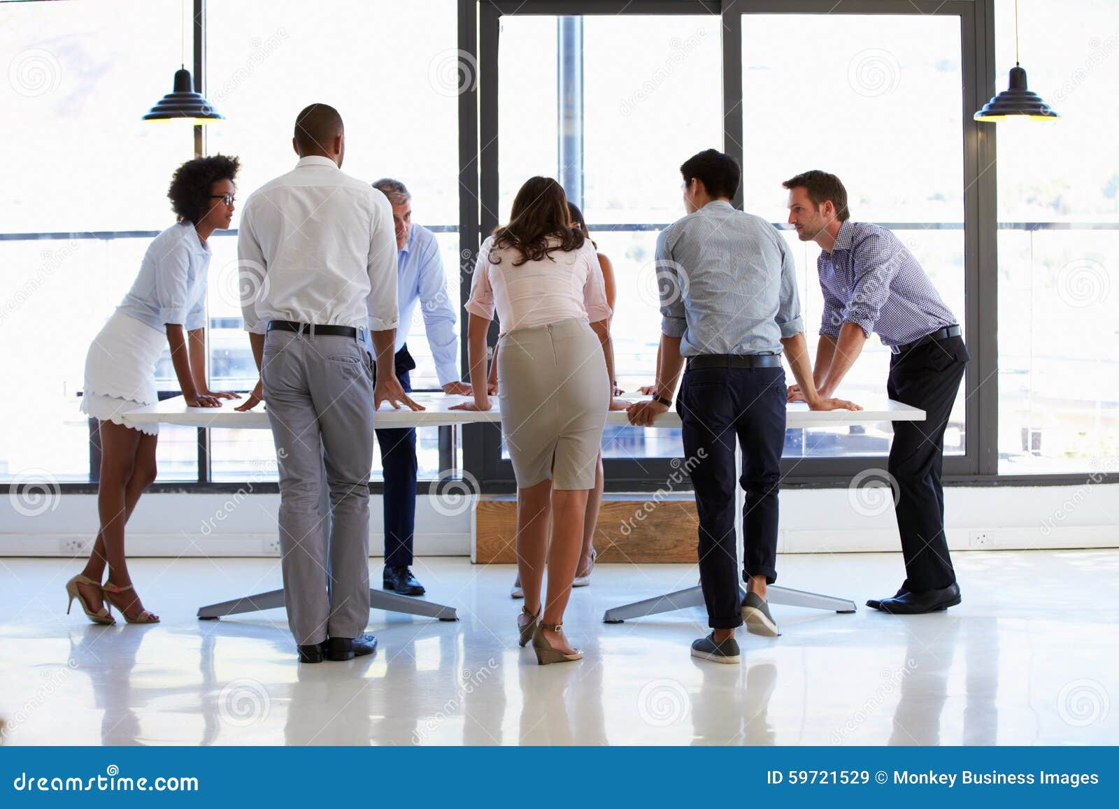 Colleagues Standing Around a Conference Table Stock Image - Image of ...