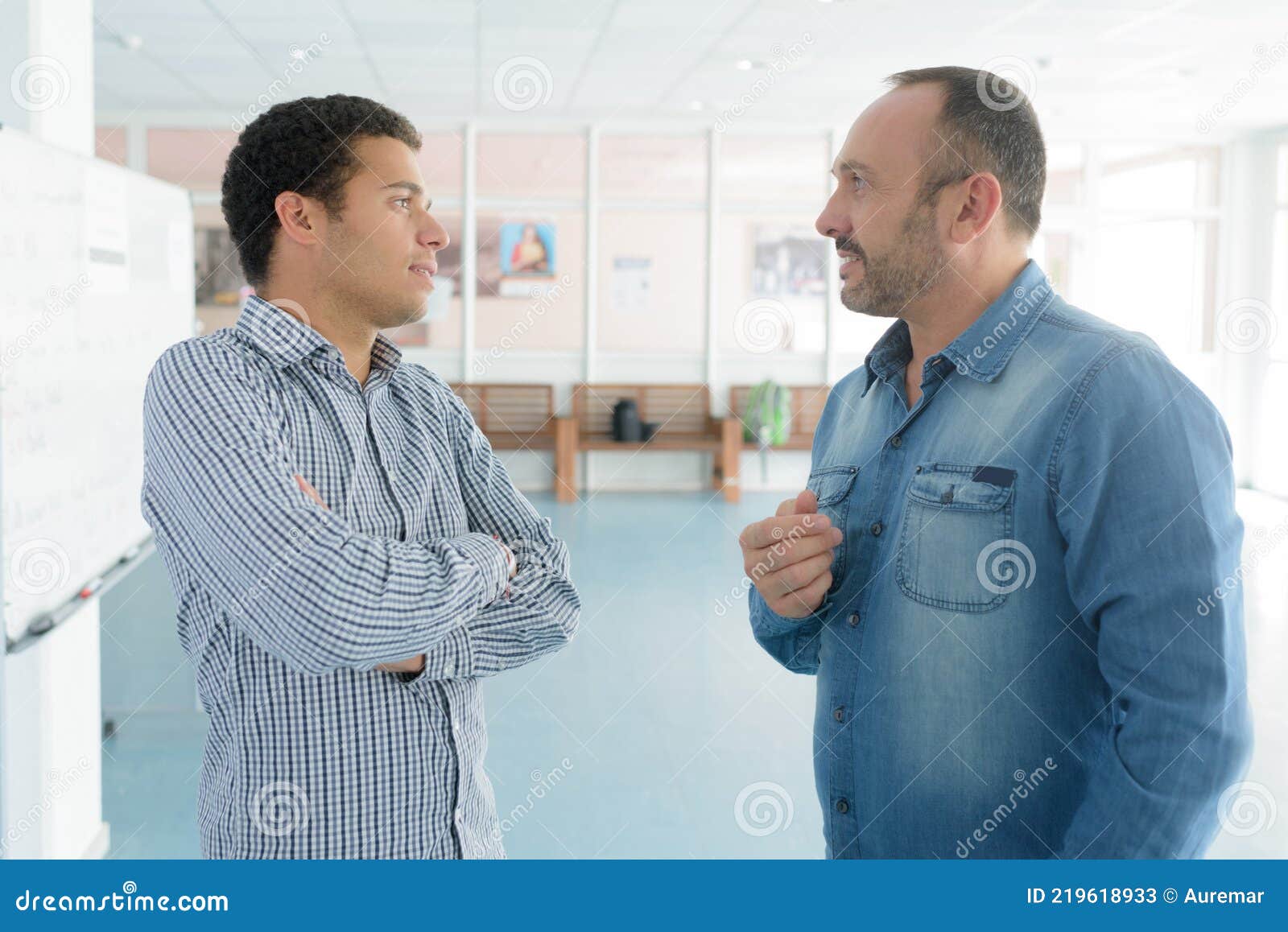 Colleagues Talking in Corridor Stock Image - Image of interact ...