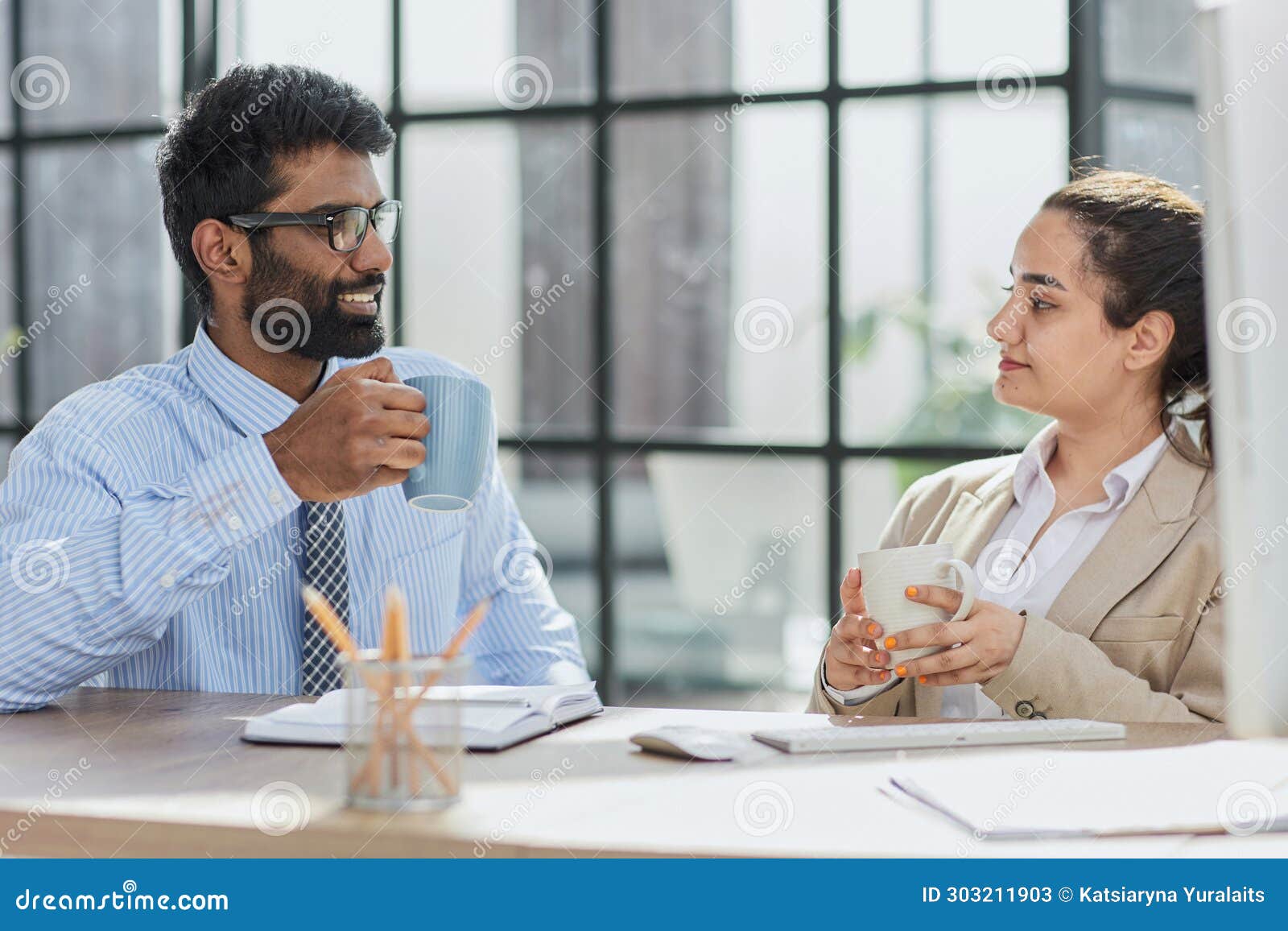 Colleagues Talking during Lunch Break while Sitting at Workplace Stock ...