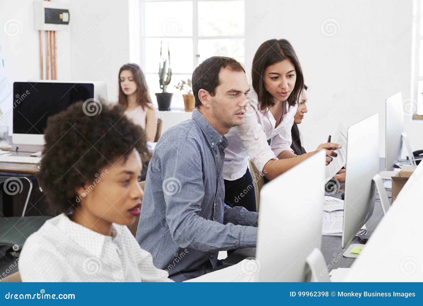 Colleagues Talking at Work in a Busy Open Plan Office, Close Up Stock ...
