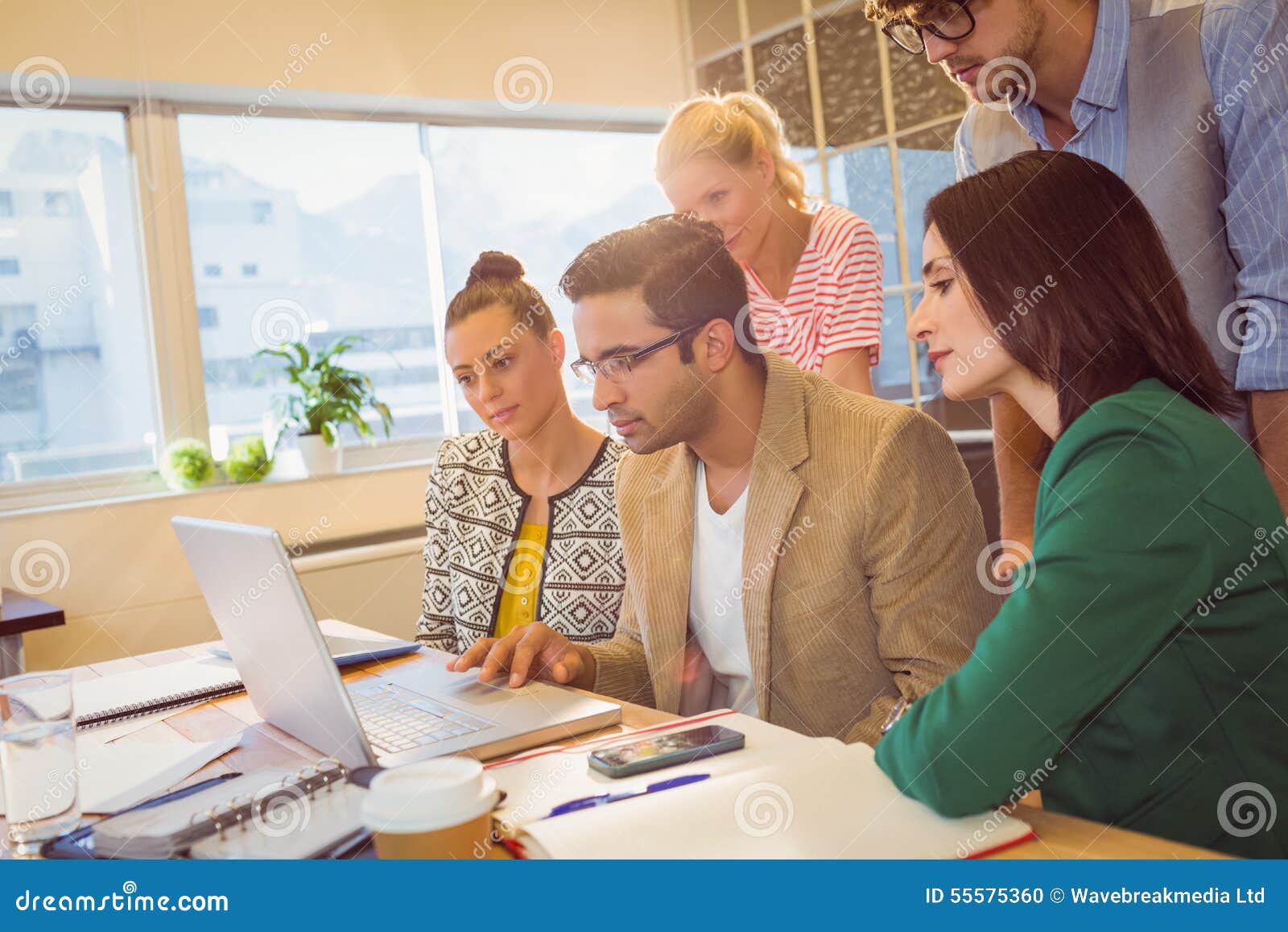 Colleagues Using Laptop in Office Stock Photo - Image of attractive ...