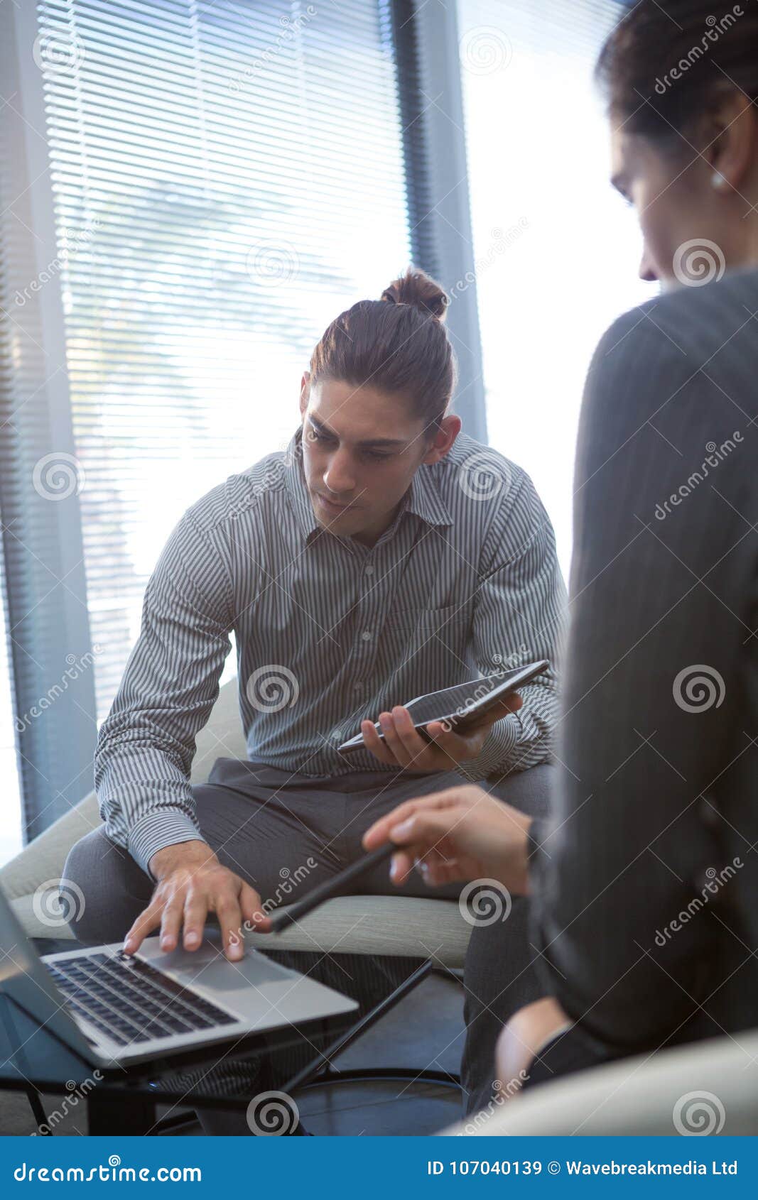 Colleagues Using Laptop in Waiting Area Stock Image - Image of company ...