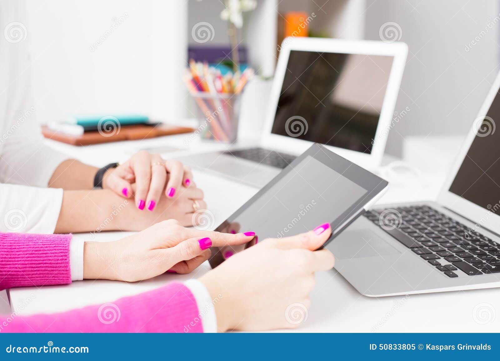 Colleagues Using Tech Gadgets at Work Stock Image - Image of laptop ...