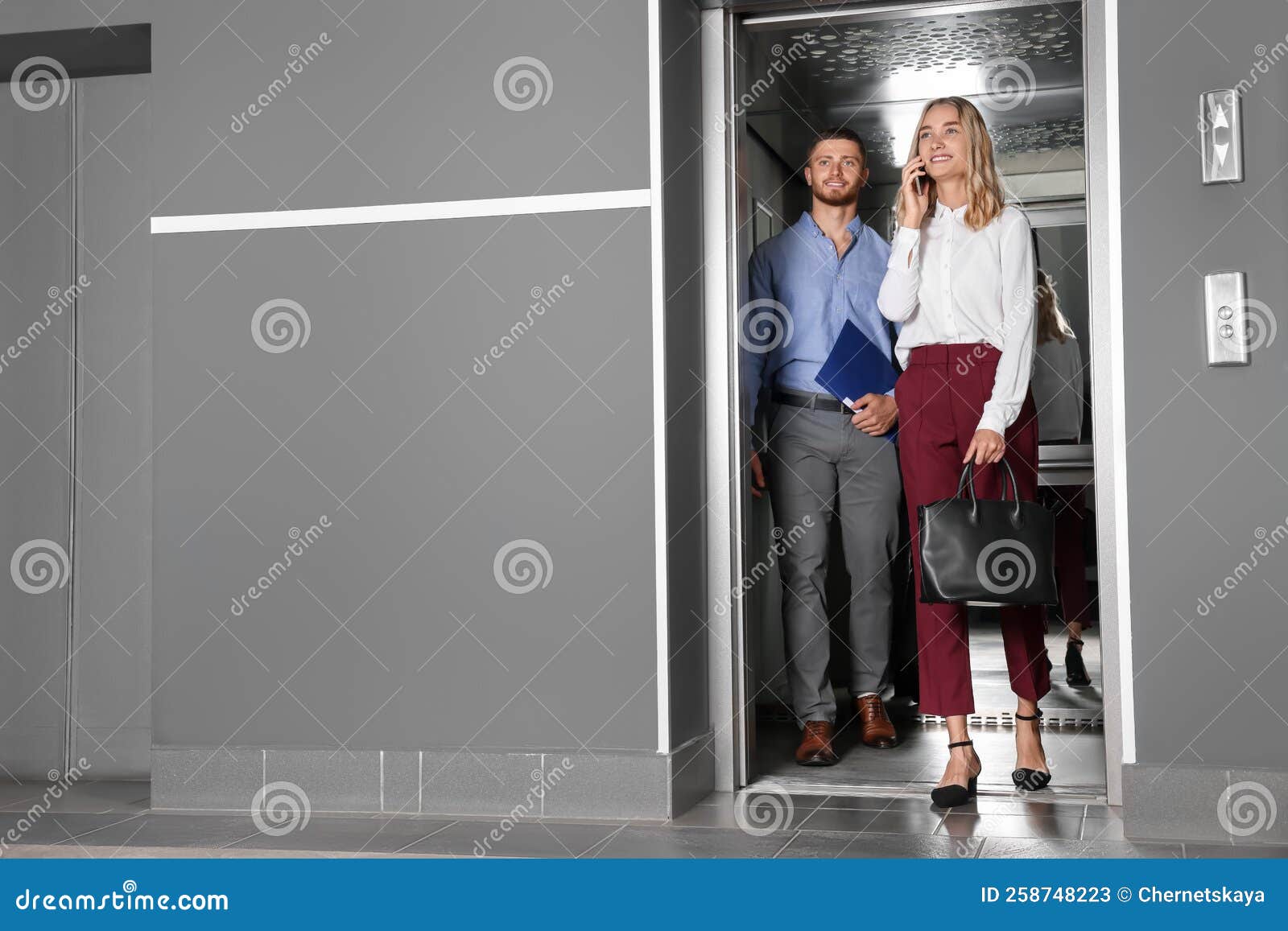 Colleagues Walking Out Modern Elevator in Office Building Stock Image ...