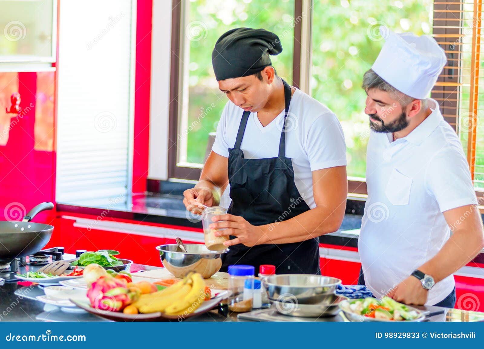 Colleagues at Work: Thai and European Chefs at the Kitchen Doing Stock ...