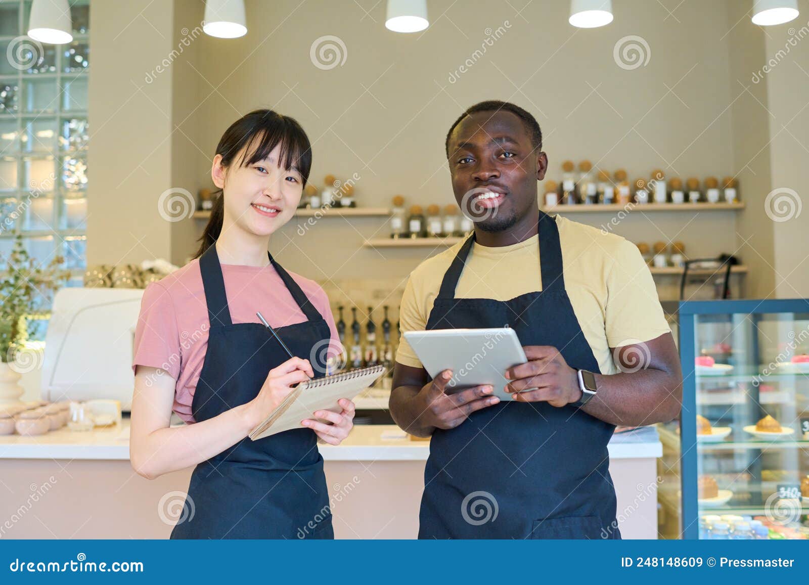 Colleagues Working in Team in Cafe Stock Image - Image of notepad ...