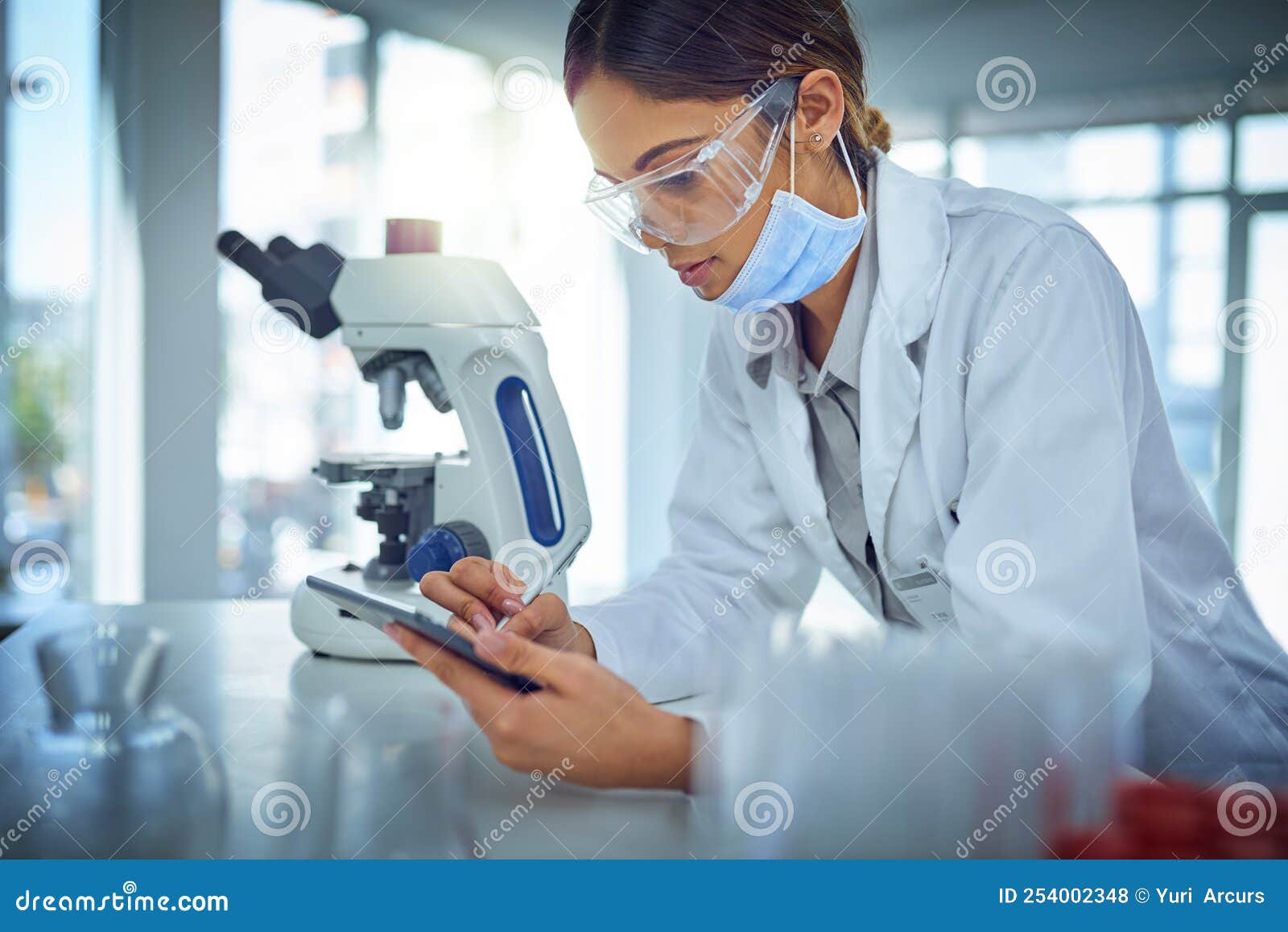 Collecting Data on Her Device. a Female Scientist Using a Digital ...