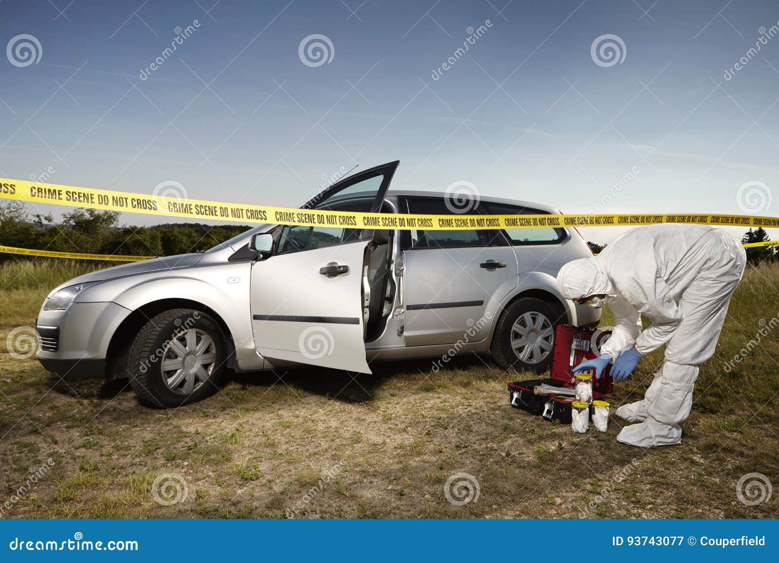 Collecting Of Evidences And Traces By Criminologist Around Car Stock