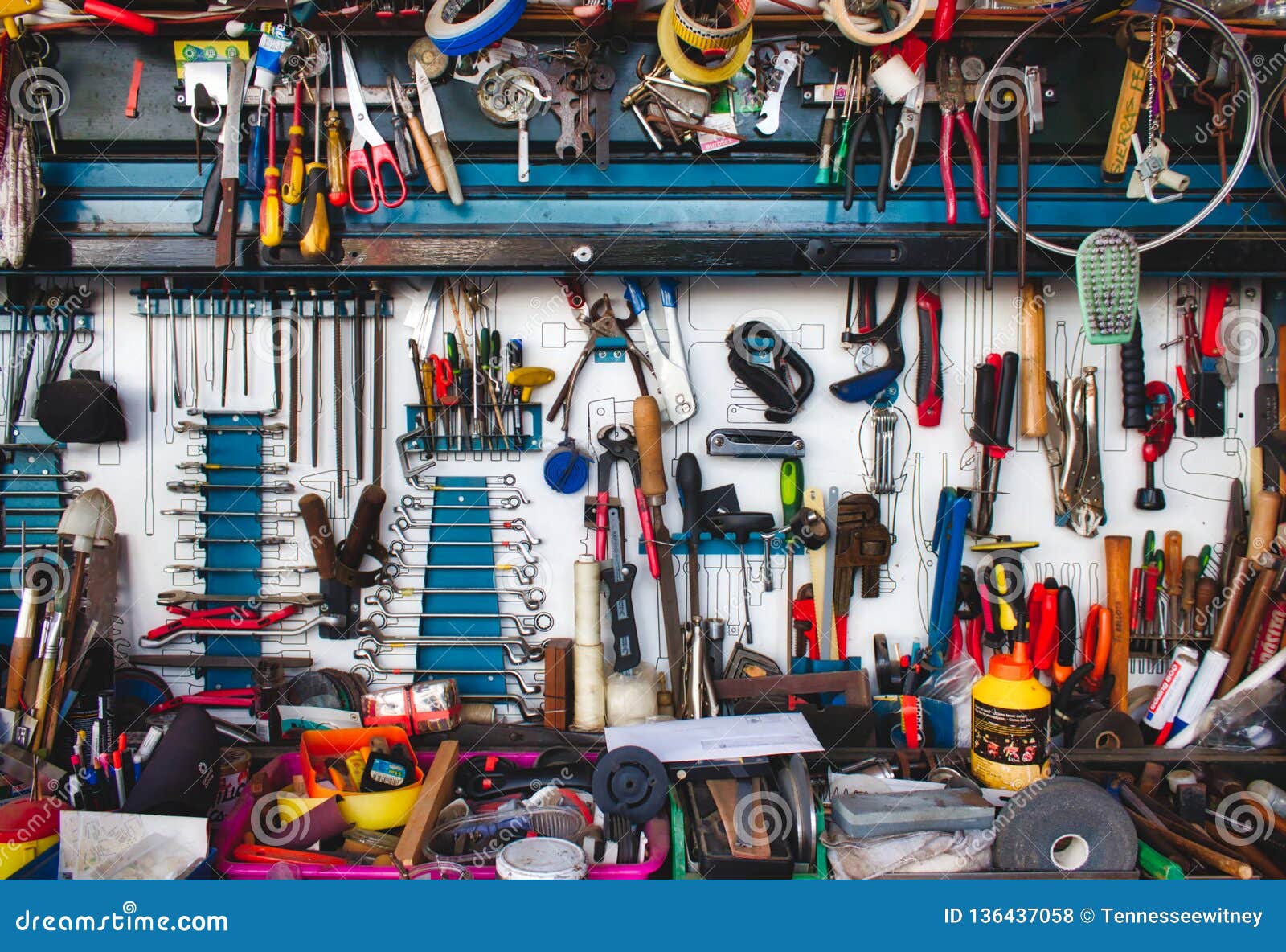 A Collection of Assorted Tools Hanging on the Wall with a Work Bench ...