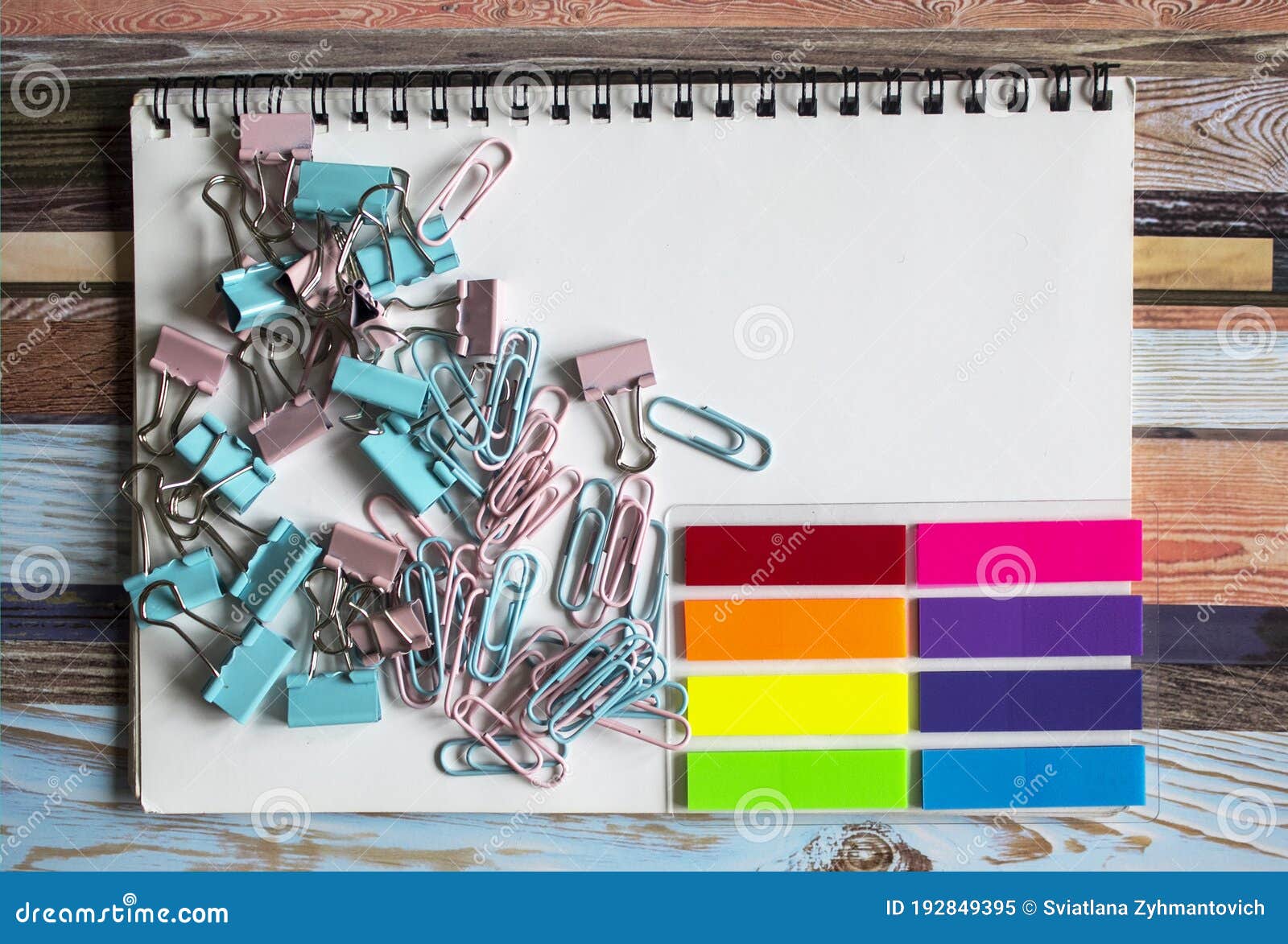 Collection of Different Types of Paper Clips on a White Notepad and ...