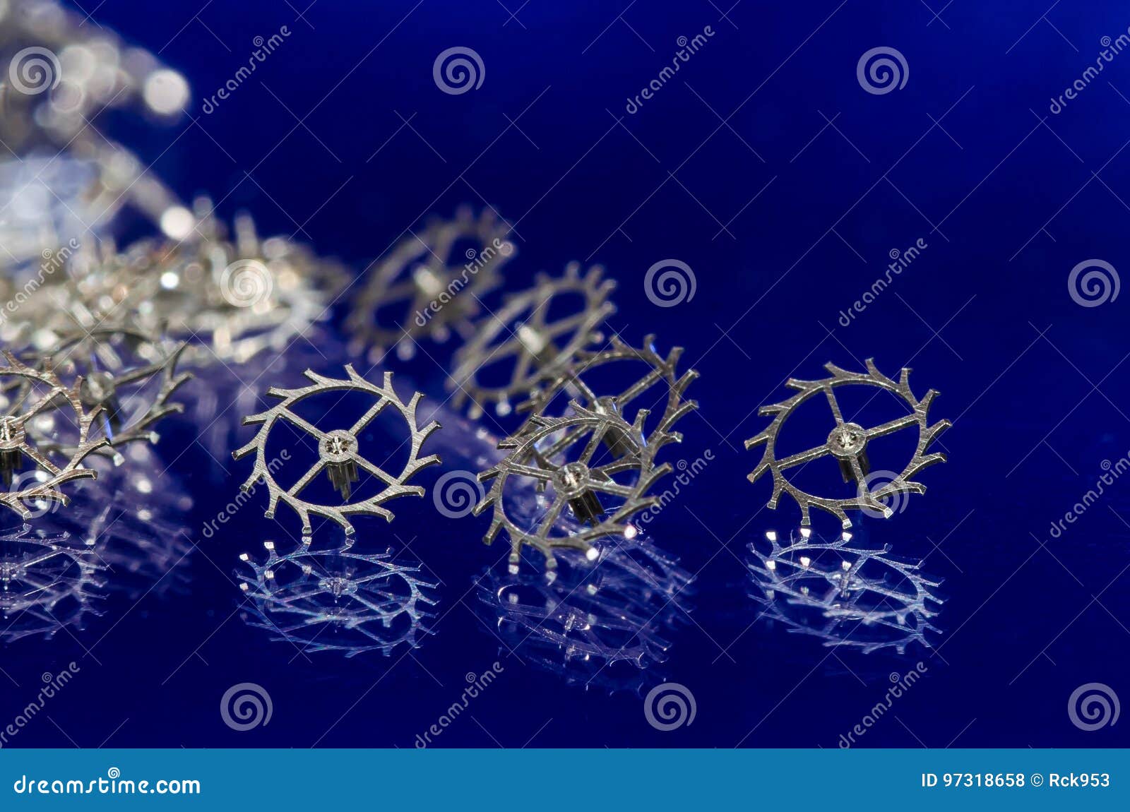 Collection of Escape Wheels Resting in a Blue Surface Stock Photo ...