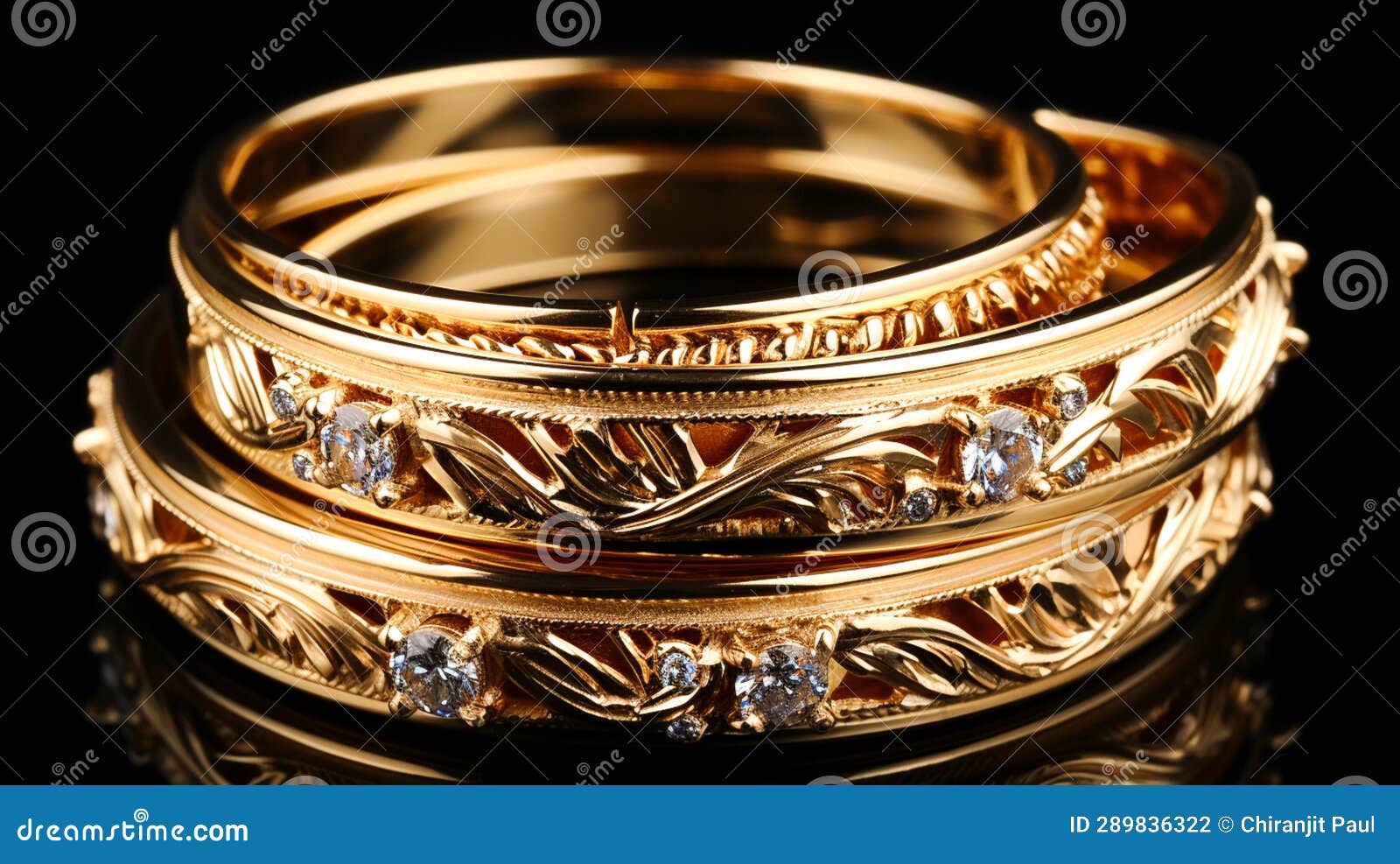 A Collection of Gold Bangles and Bracelets with Diamonds on Black ...
