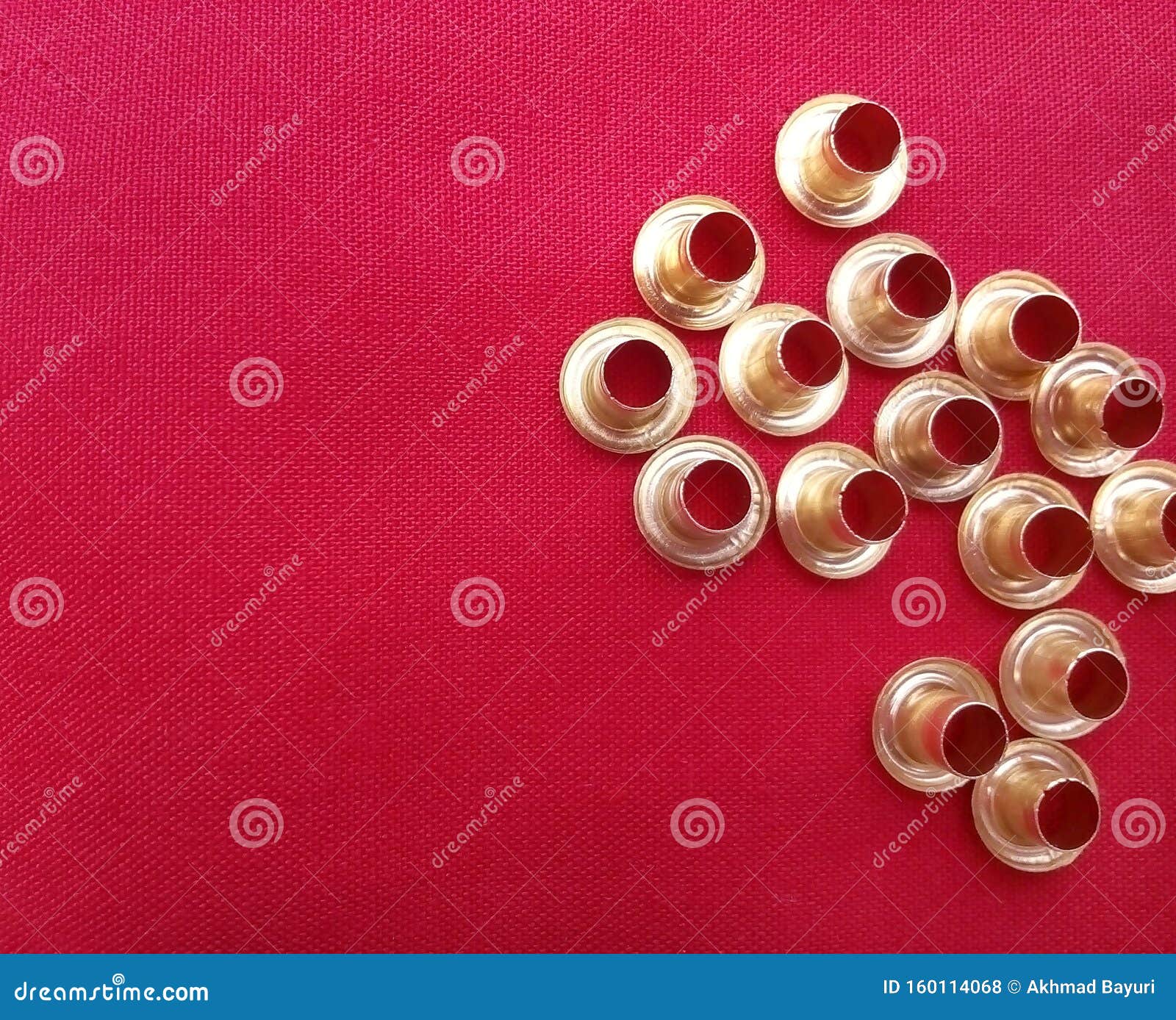 A Collection of Gold Eyelet on a Textured Red Cloth Stock Photo - Image ...