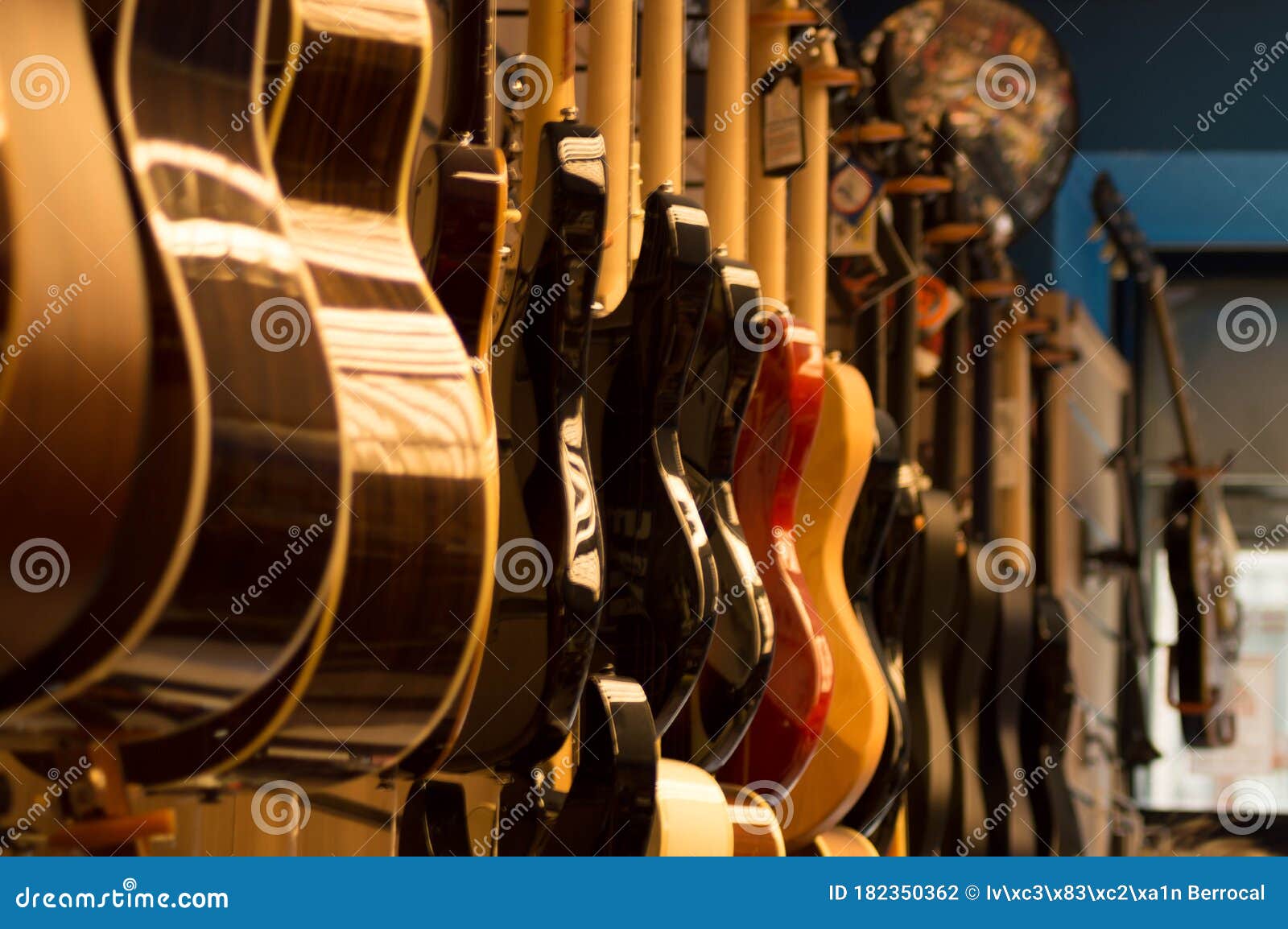 Collection of Guitars Hanging in Row Stock Photo - Image of hobby, sale ...