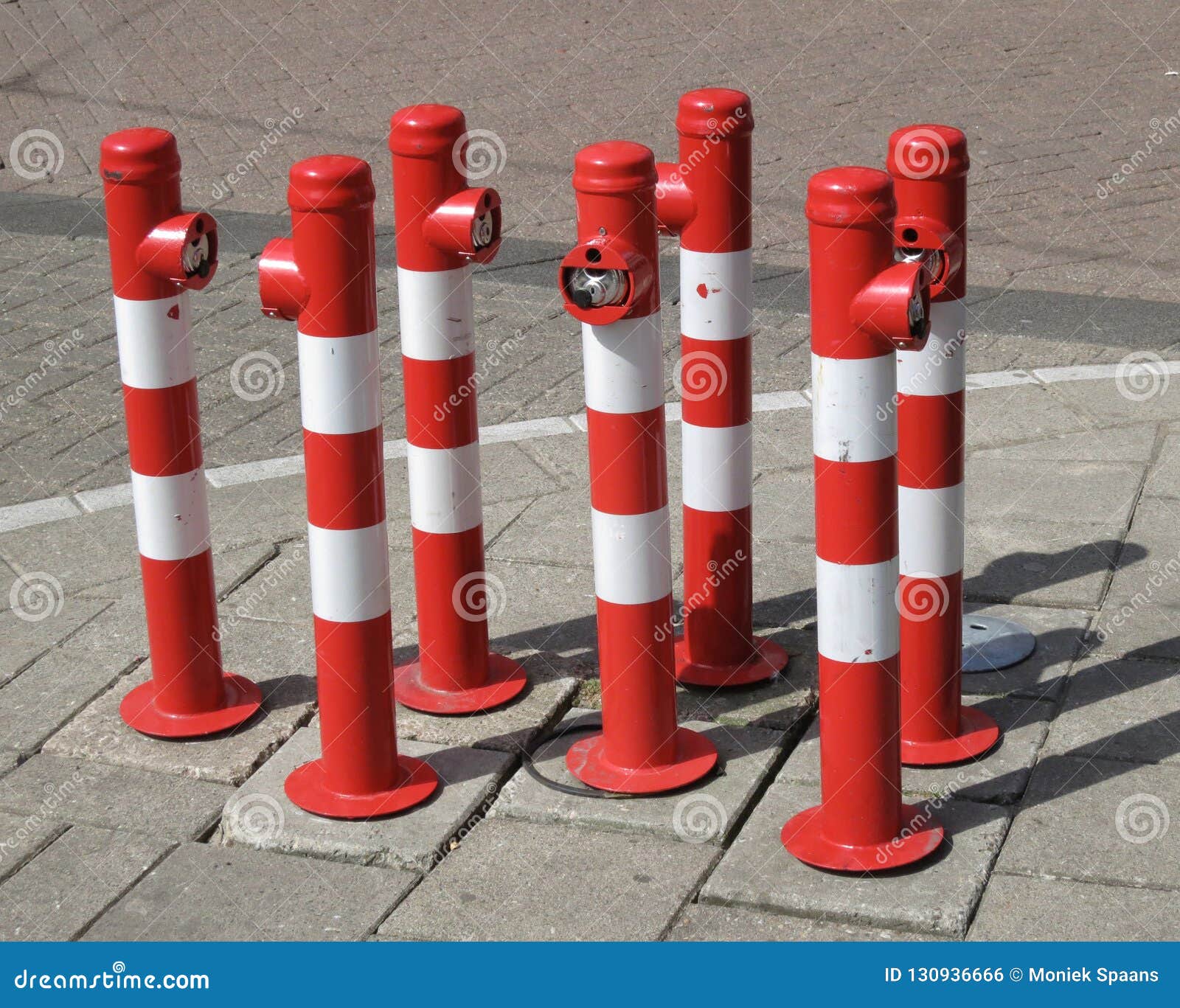 Collection of Red and White Post on the Sidewalk by the Street Stock ...