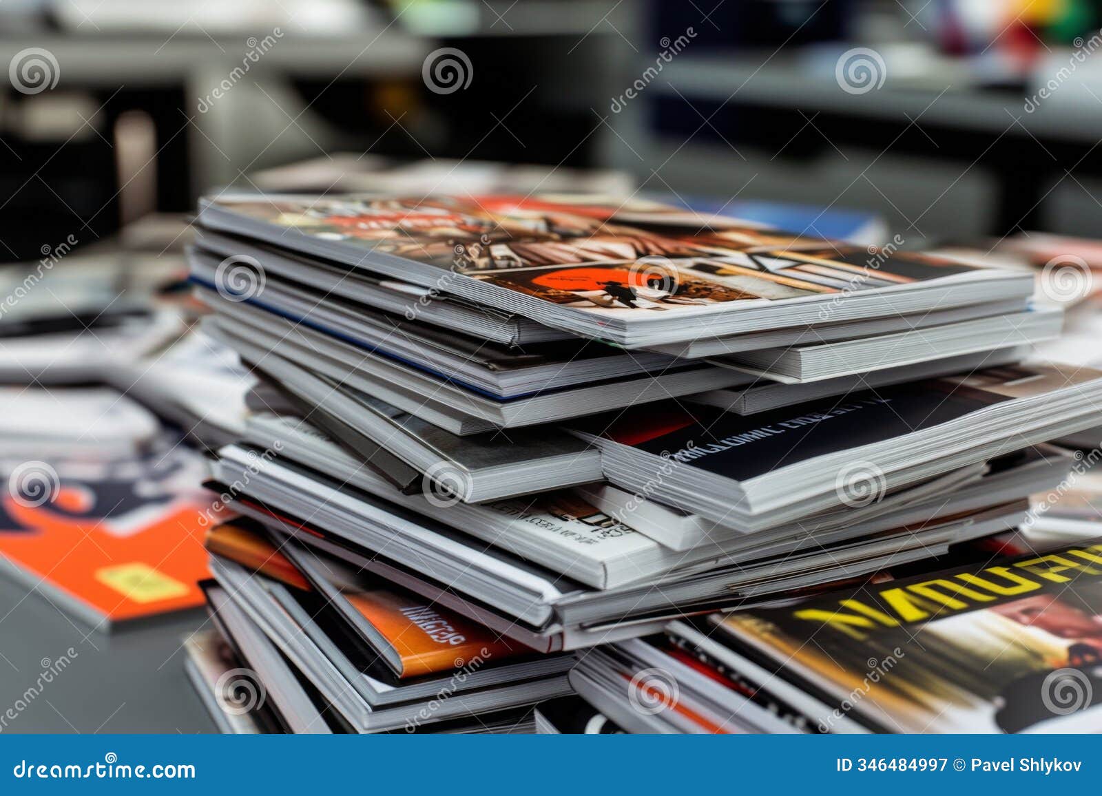 Collection of Stacked Magazines at a Workspace Showcasing Various Cover ...