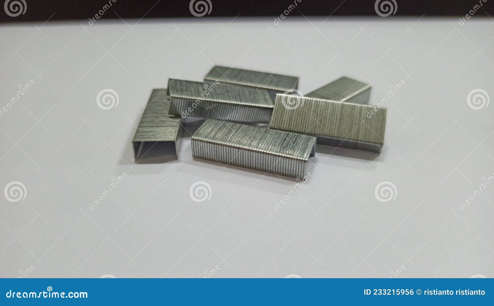 A Collection of Staples on Paper Stock Photo - Image of glass, wing ...
