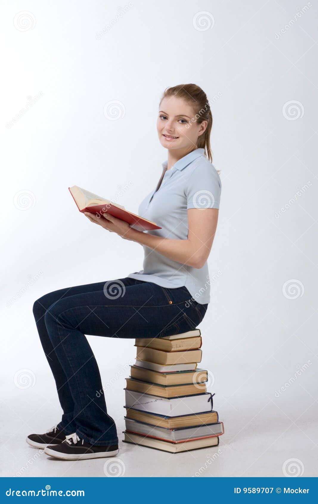 College Female Student Sitting on Stack Books Stock Image - Image of ...