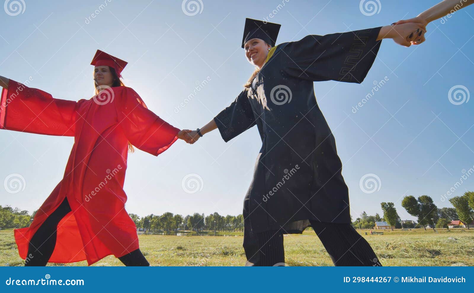 College Graduates Holding Hands Run in a Round Dance. Stock Image ...