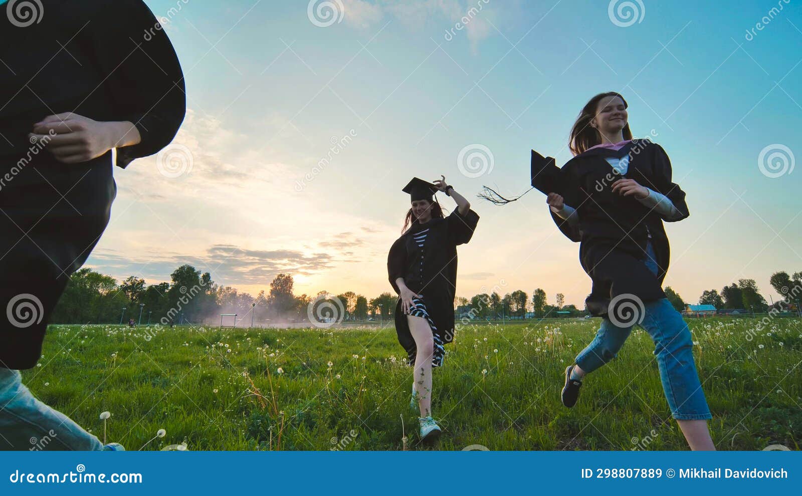 College Graduates Run at Sunset in the Evening. Stock Image - Image of ...